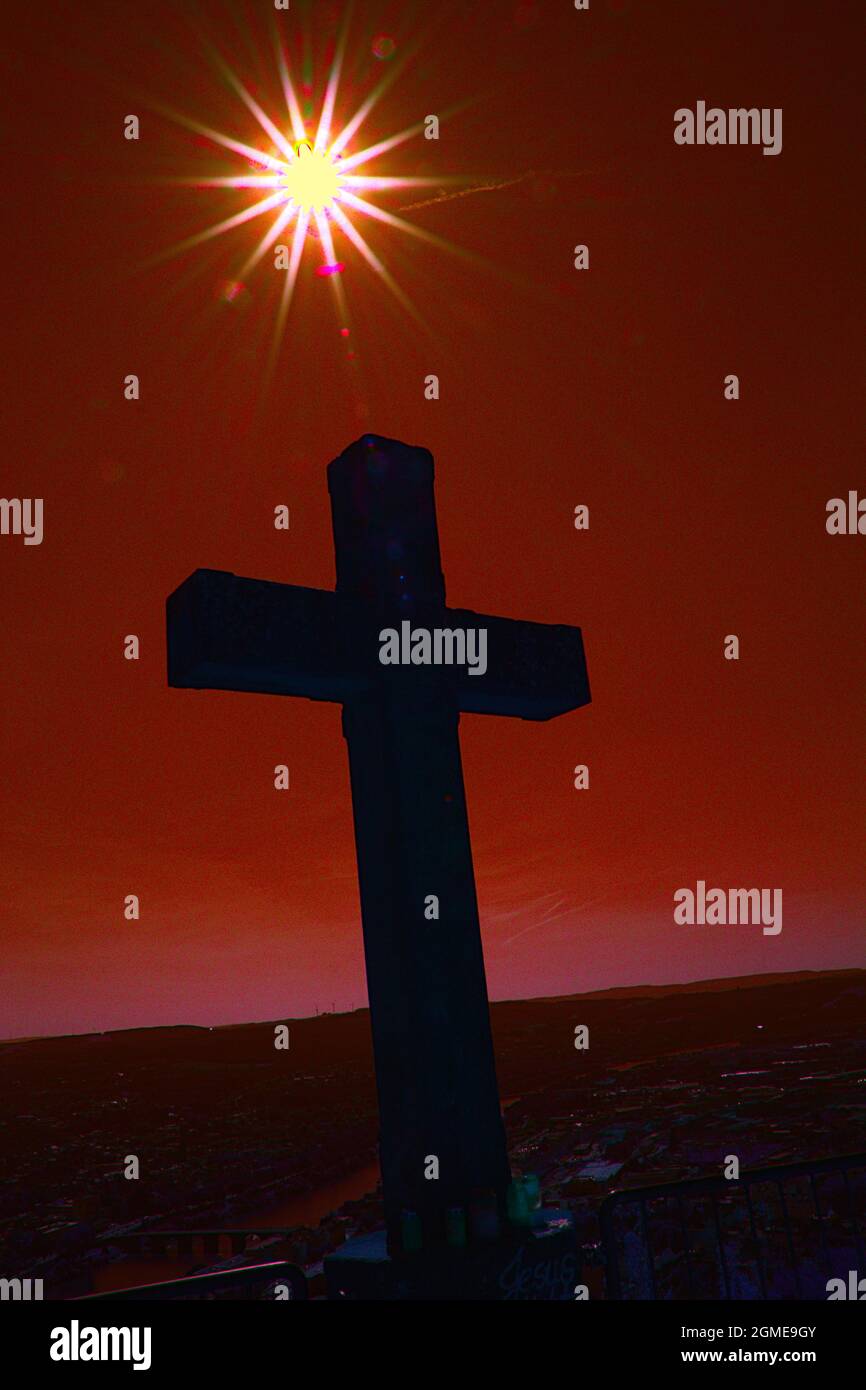 Crucifix with Sun at red sky Stock Photo - Alamy