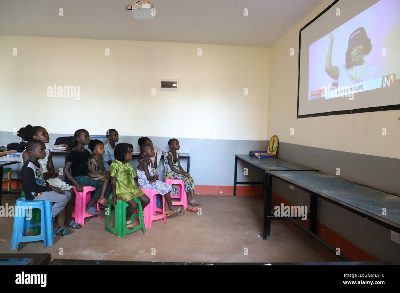 Wakiso, Uganda. 10th Sep, 2021. Children watch TV program with a ...