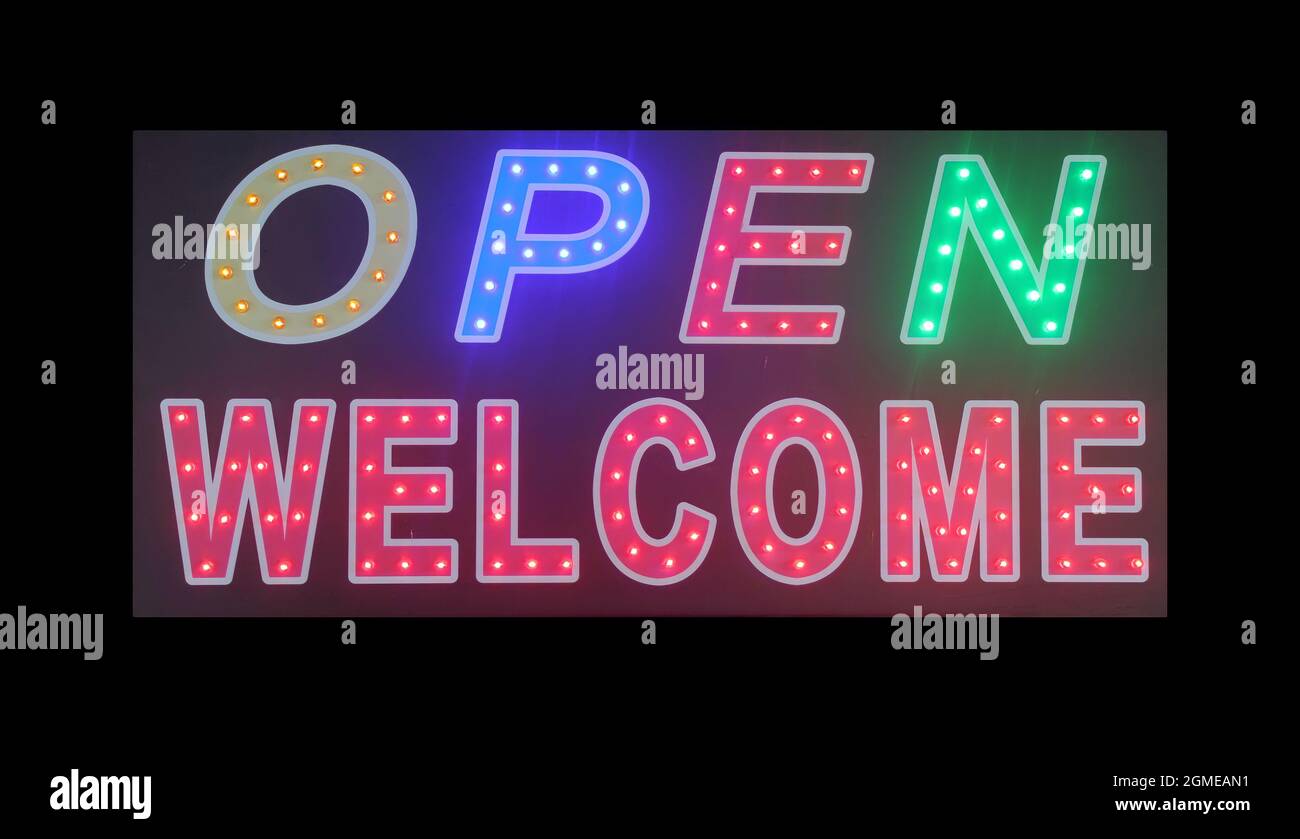 OPEN WELCOME neon light text on black background Stock Photo - Alamy