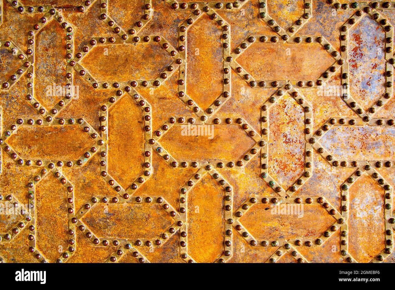 Ancient metal rusty surface with rivets and moorish pattern Stock Photo ...