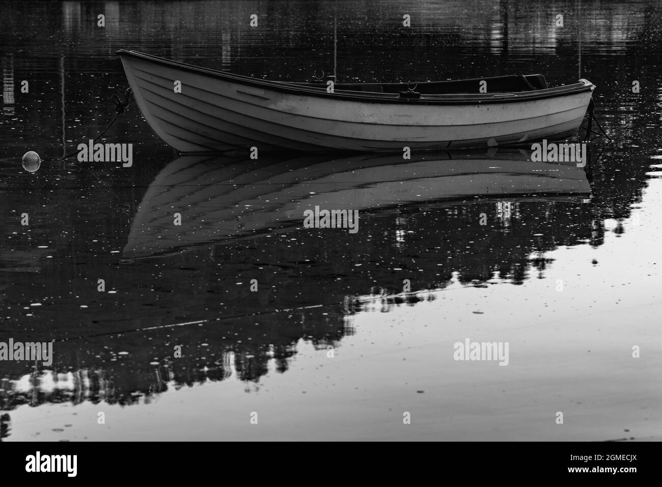 Grayscale shot of an old boat reflecting on the water Stock Photo - Alamy