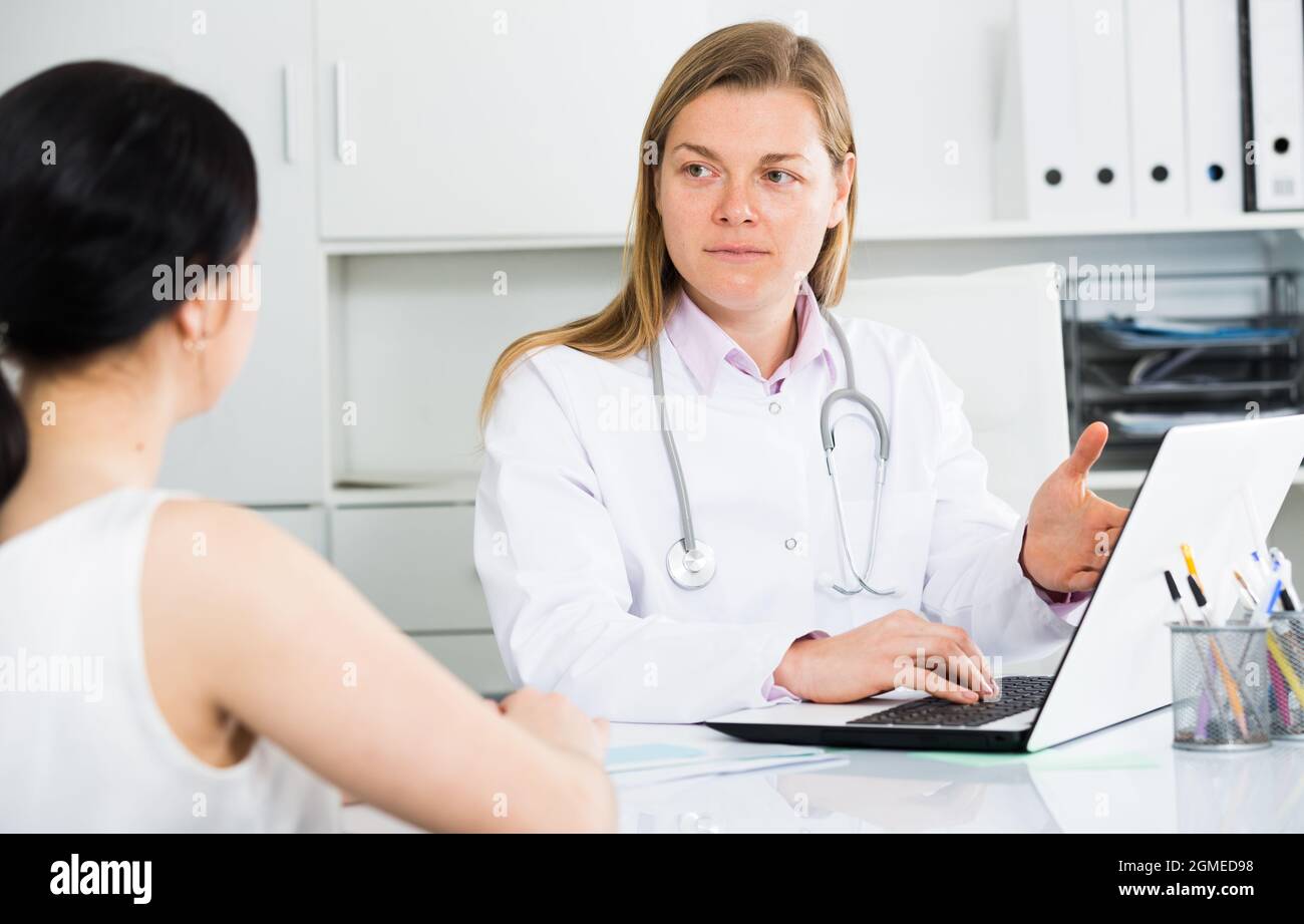 Woman visiting female doctor Stock Photo - Alamy