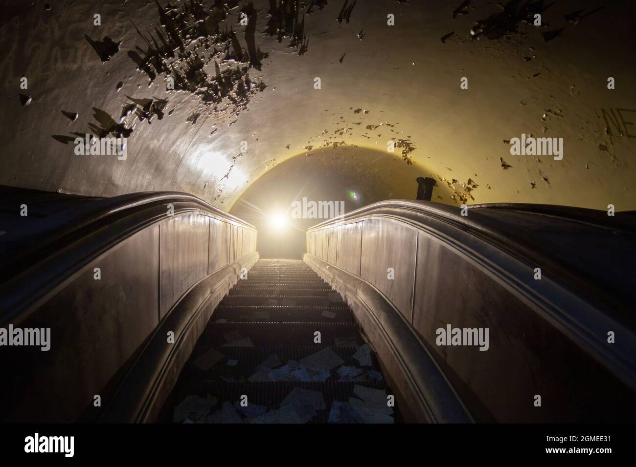 Dark and creepy old abandoned subway station. Broken escalator Stock ...