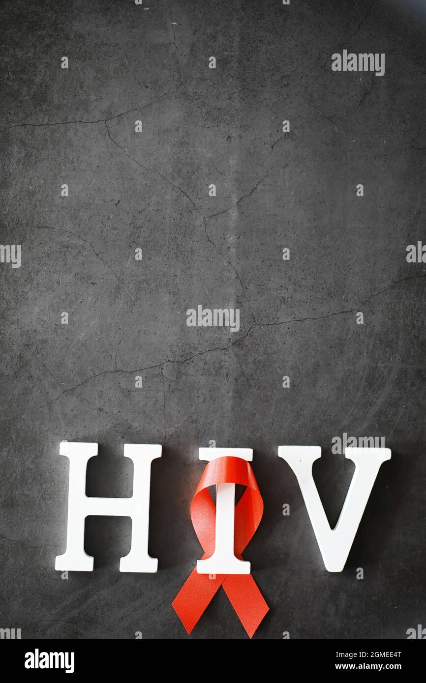 Symbol of human immunodeficiency virus disease. Red ribbon. A helping ...