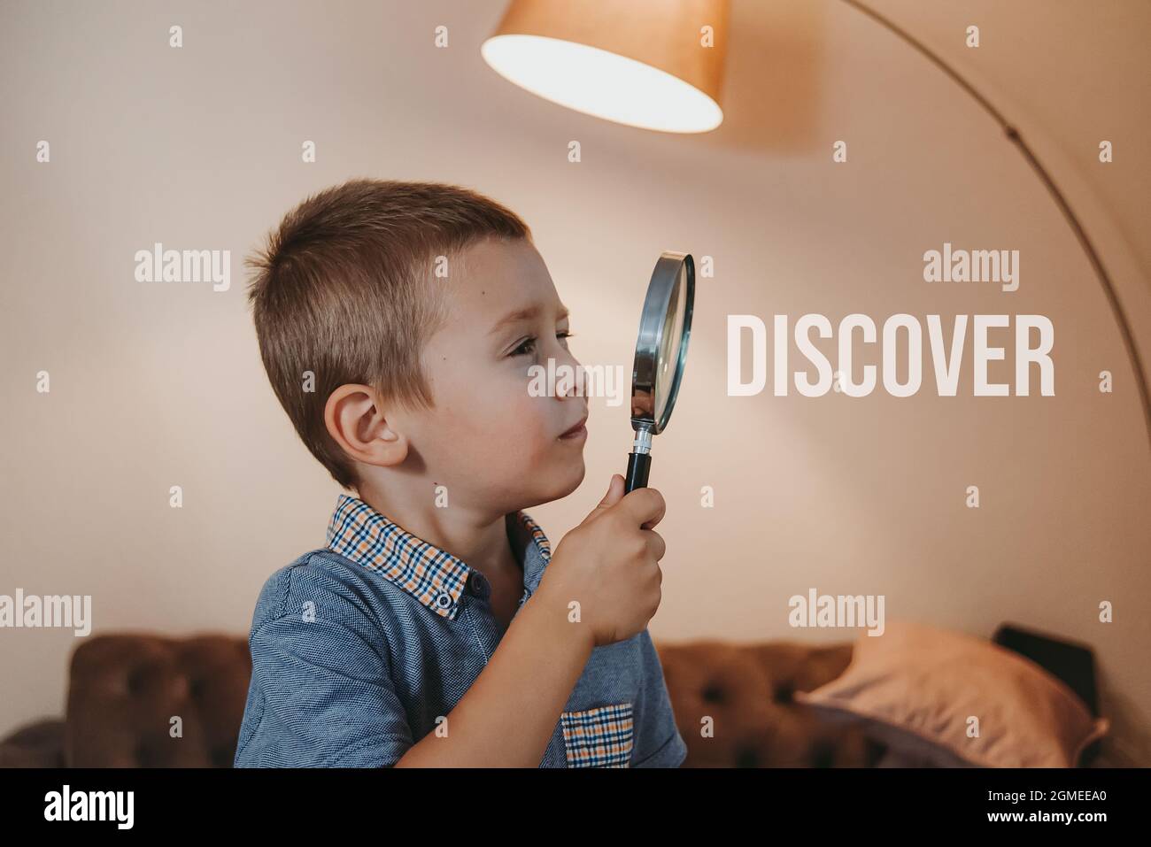Child holding a magnifying glass with text discover concept Stock Photo ...