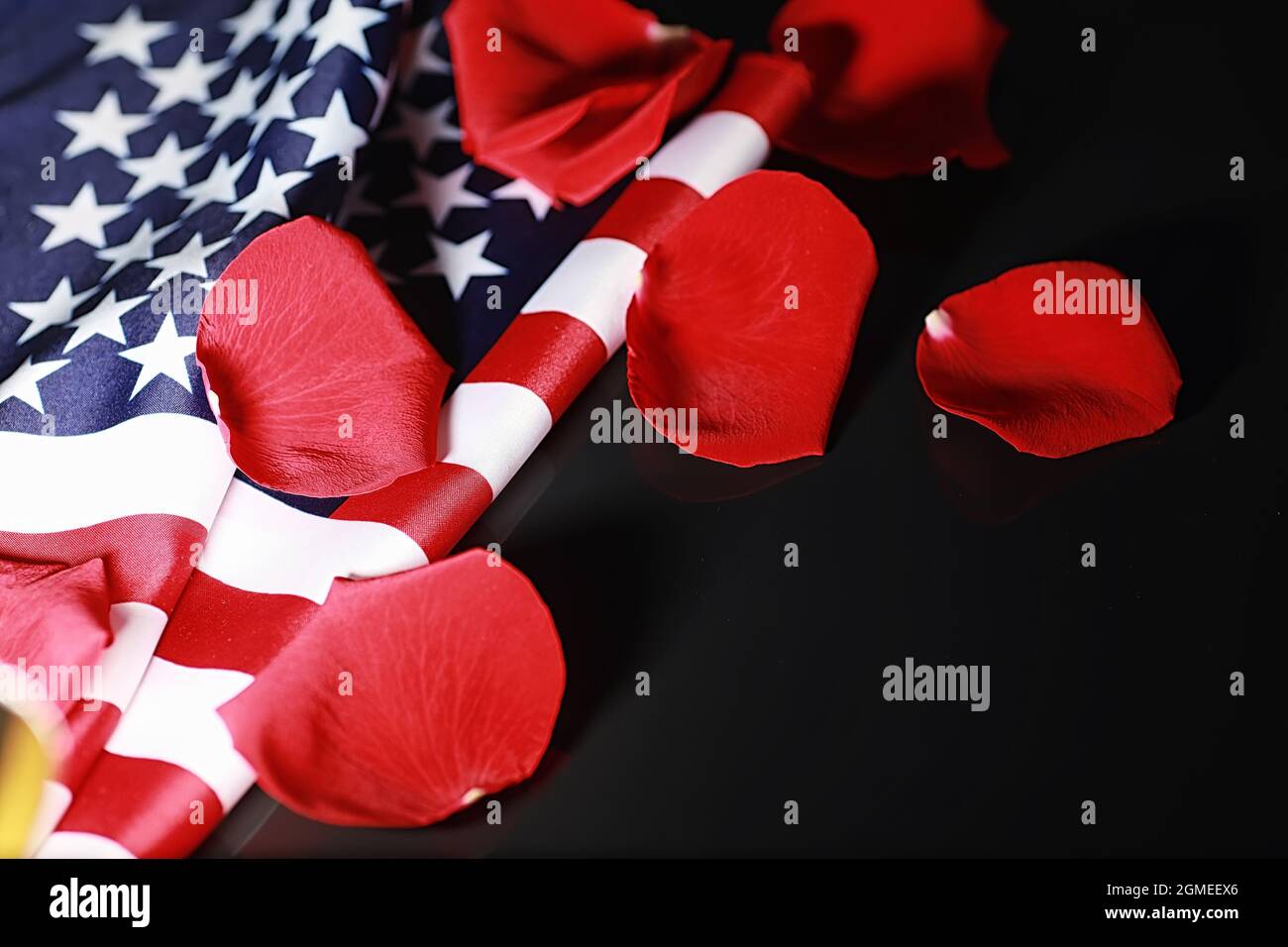 American flag and rose flower on table. Symbol of the United States of ...