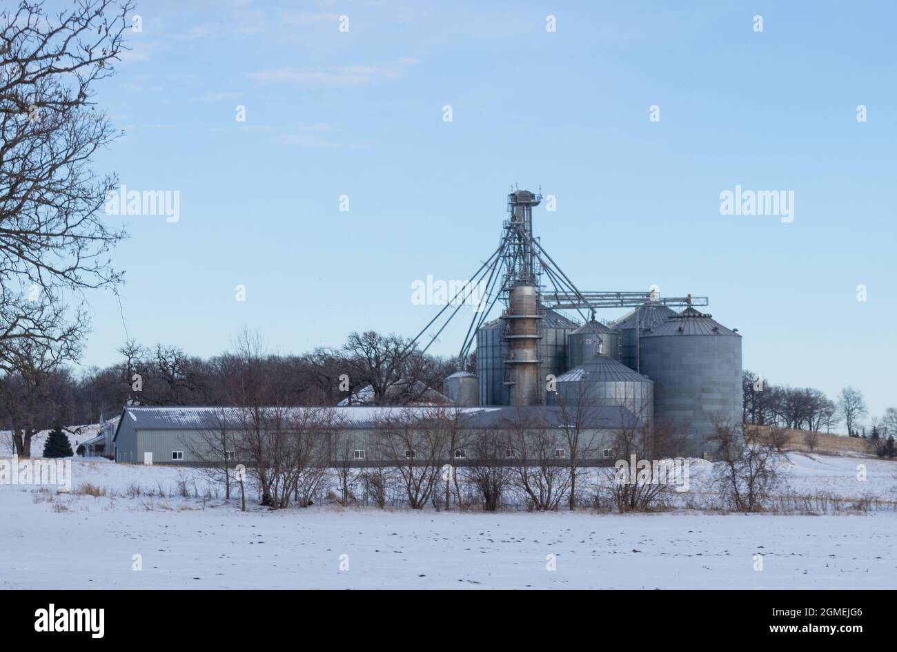 Farm silos with connecting elevators and barns in the winter months ...