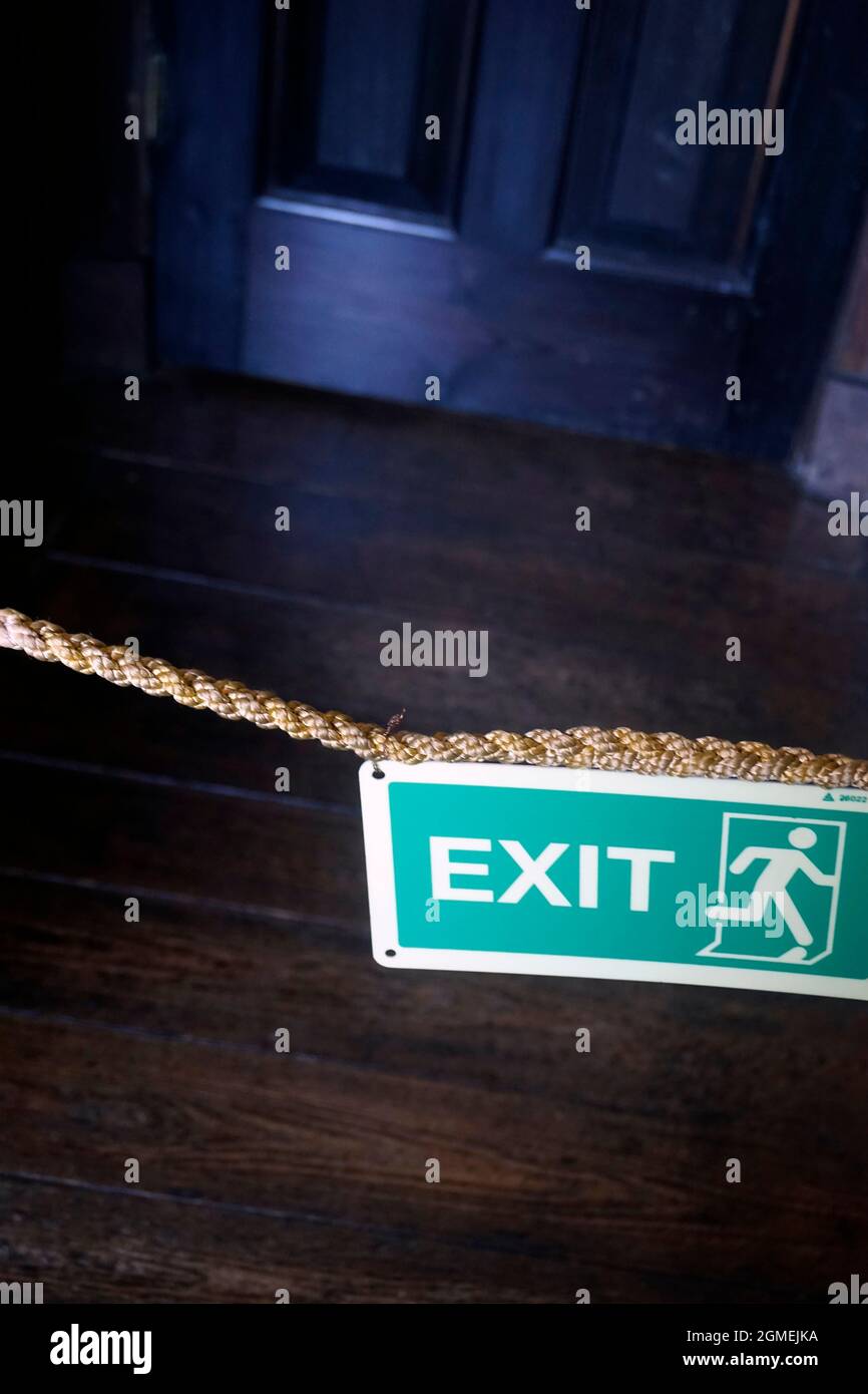 exit sign hanging on piece of rope Stock Photo - Alamy