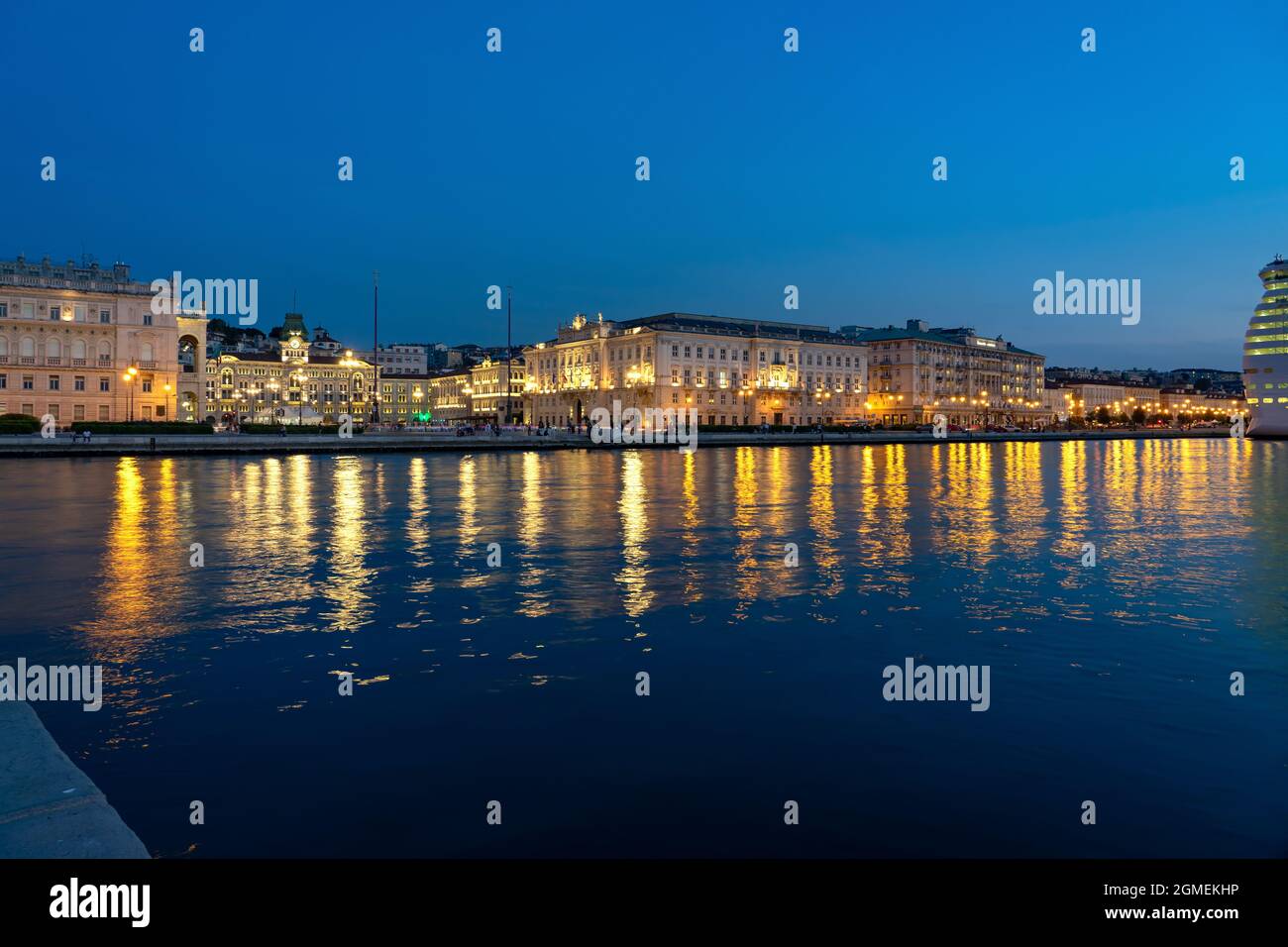 sea coast in Trieste Italy with beautiful illuminated buildings and ...
