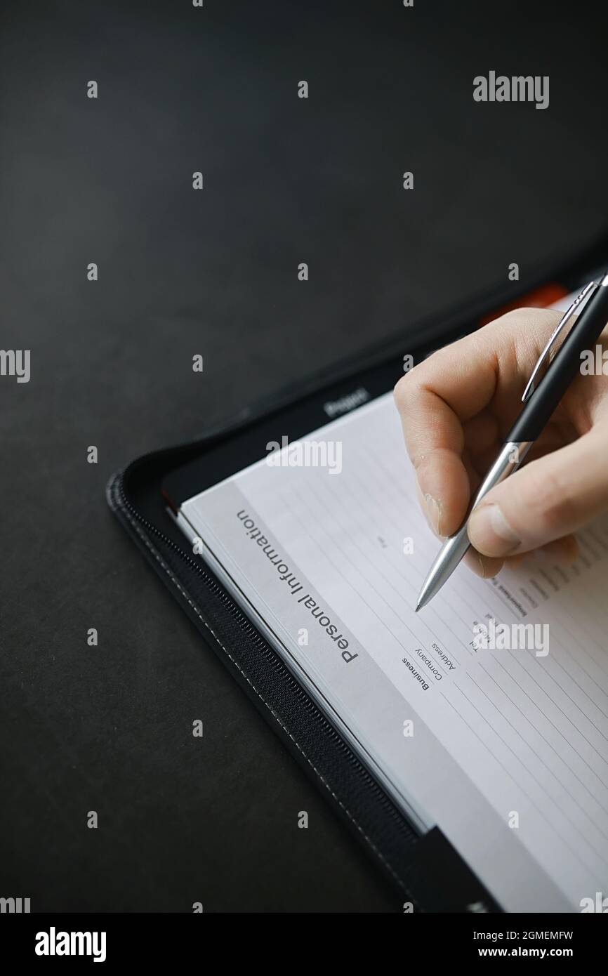Filling out a form with personal information. Documents in a folder on ...