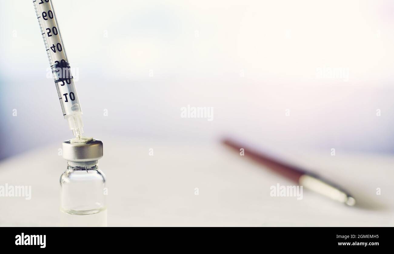 A man signs a medical document. Medical equipment on the table ...