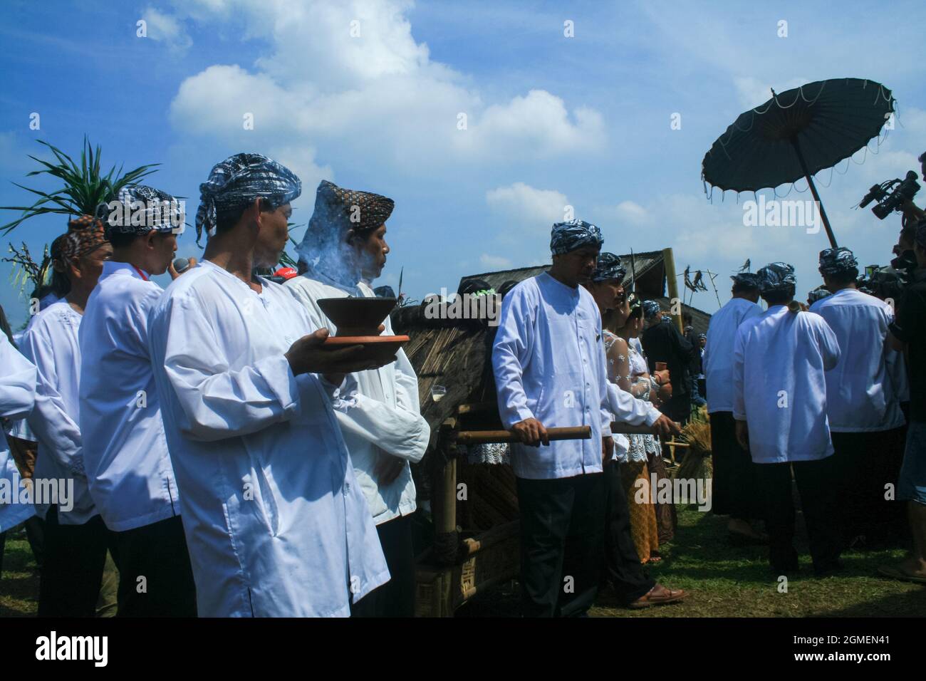 A group of men carrying incense during a carnival procession at the ...