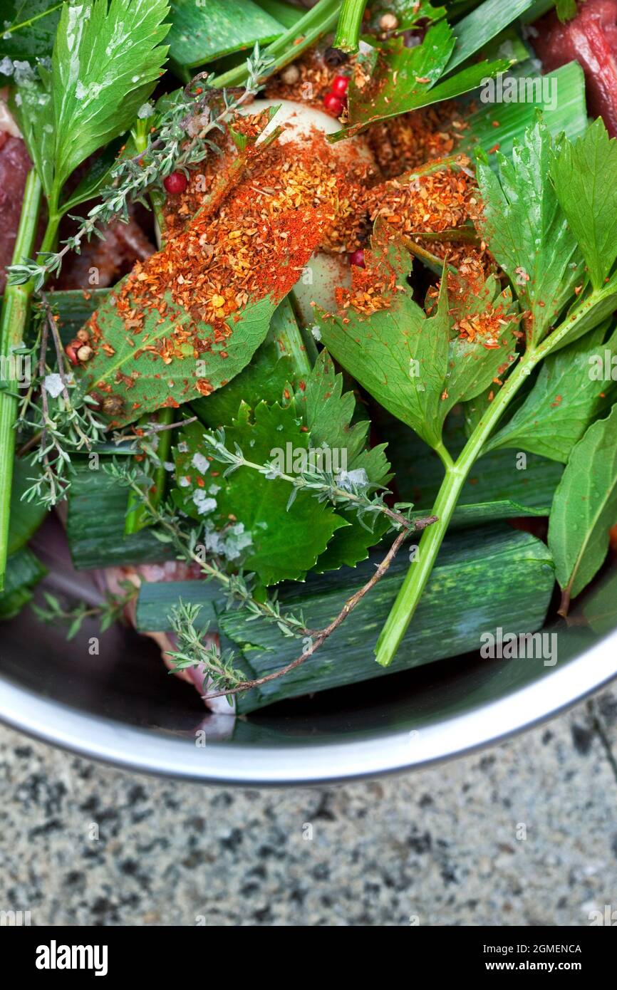 Closeup of herbs and spices in a pot before baking a French pot au feu ...
