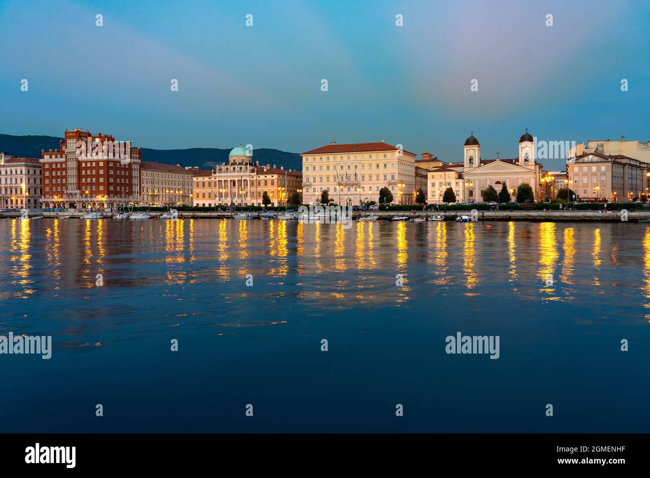 sea coast in Trieste Italy with beautiful illuminated buildings Saint ...
