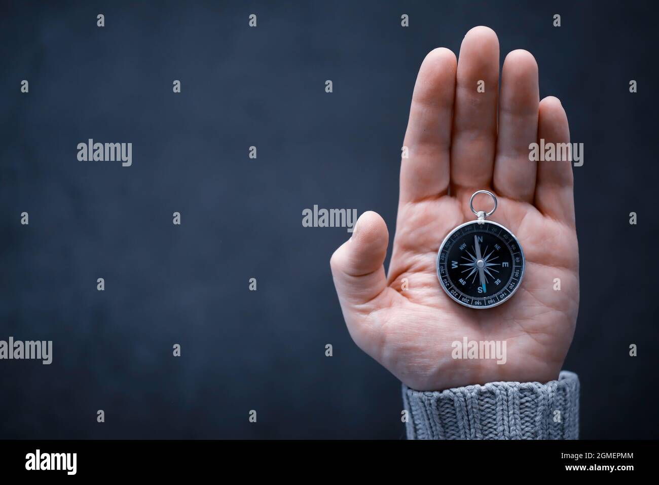 Travel concept. Magnetic compass in the hand. Retro navigator in hand ...