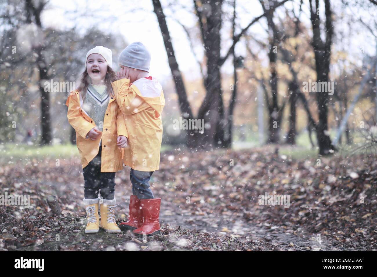 Kids walk in the park with first snow Stock Photo - Alamy