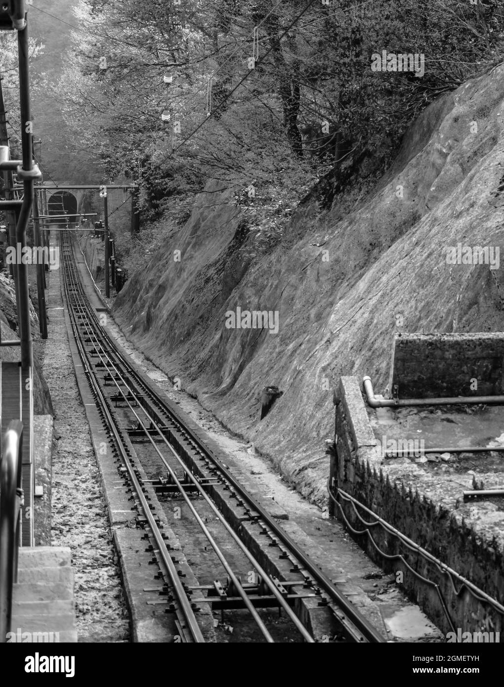 Tourist tram railway downhill to mountain tunnel with color filter ...