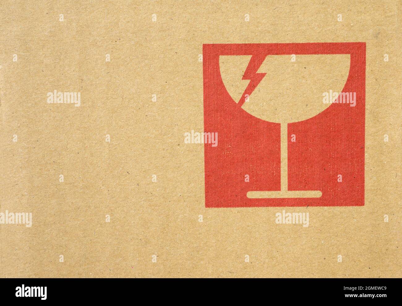 Safety fragile icon on cardboard paper box background Stock Photo - Alamy