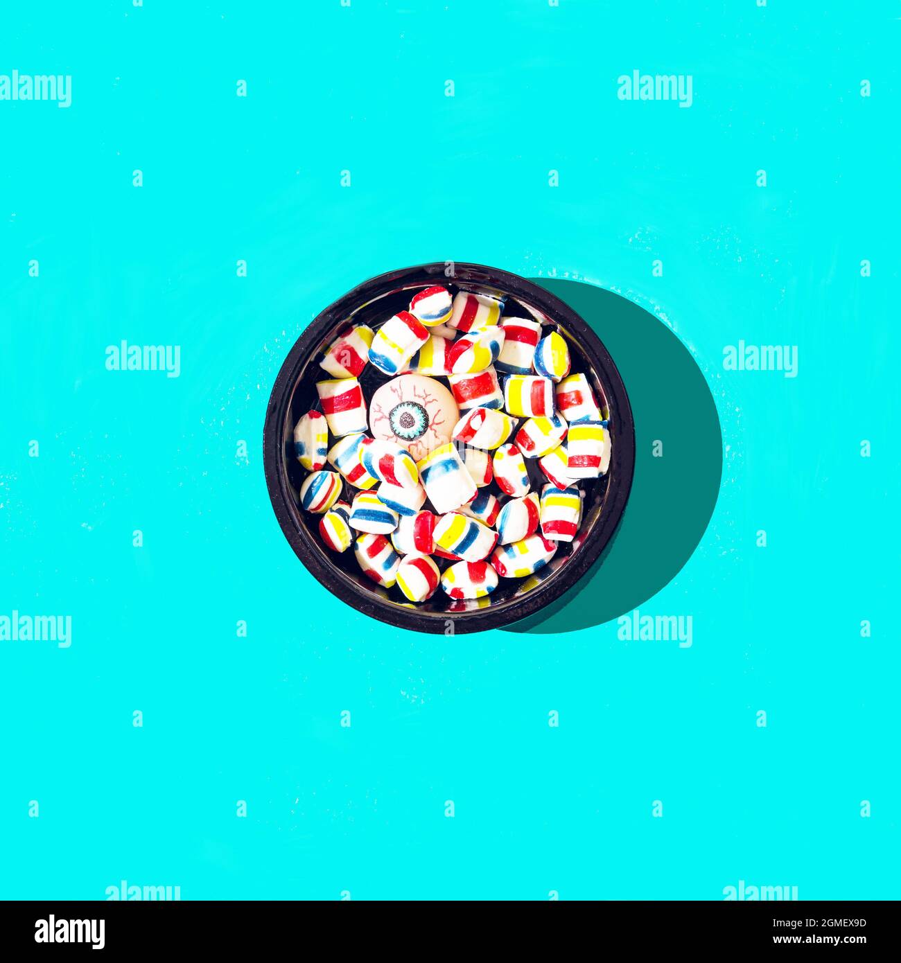 A black bawl full of candies and one scary eye ball. Trick or treat ...