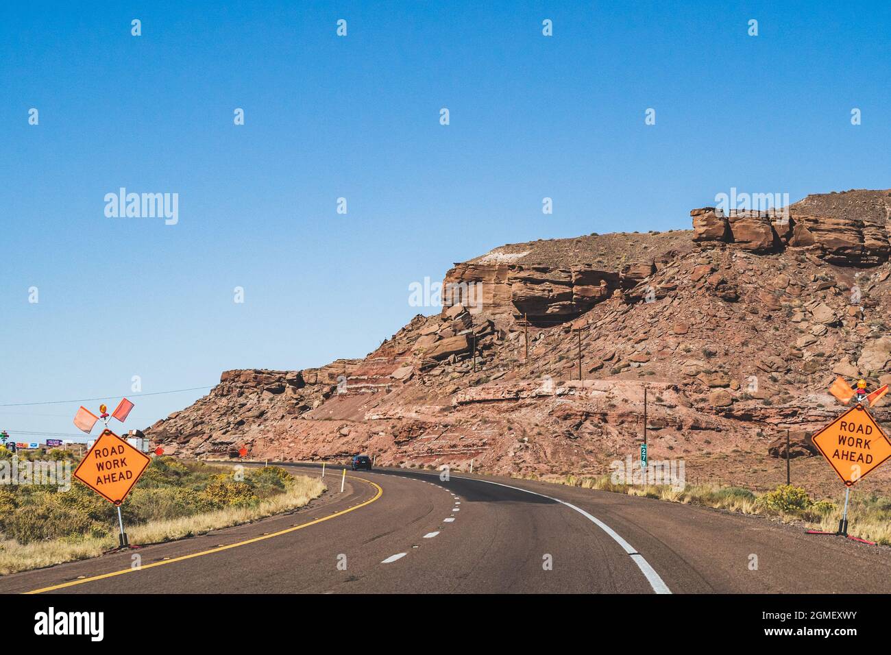 Orange Road work ahead caution signs on empty highway in southwest ...