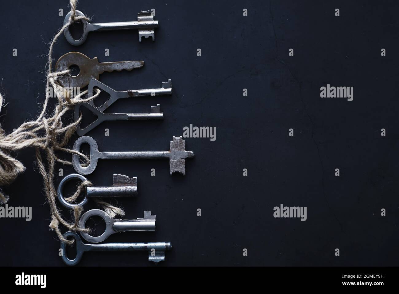 Set of vintage keys for lock. Retro keys on a dark stone background ...