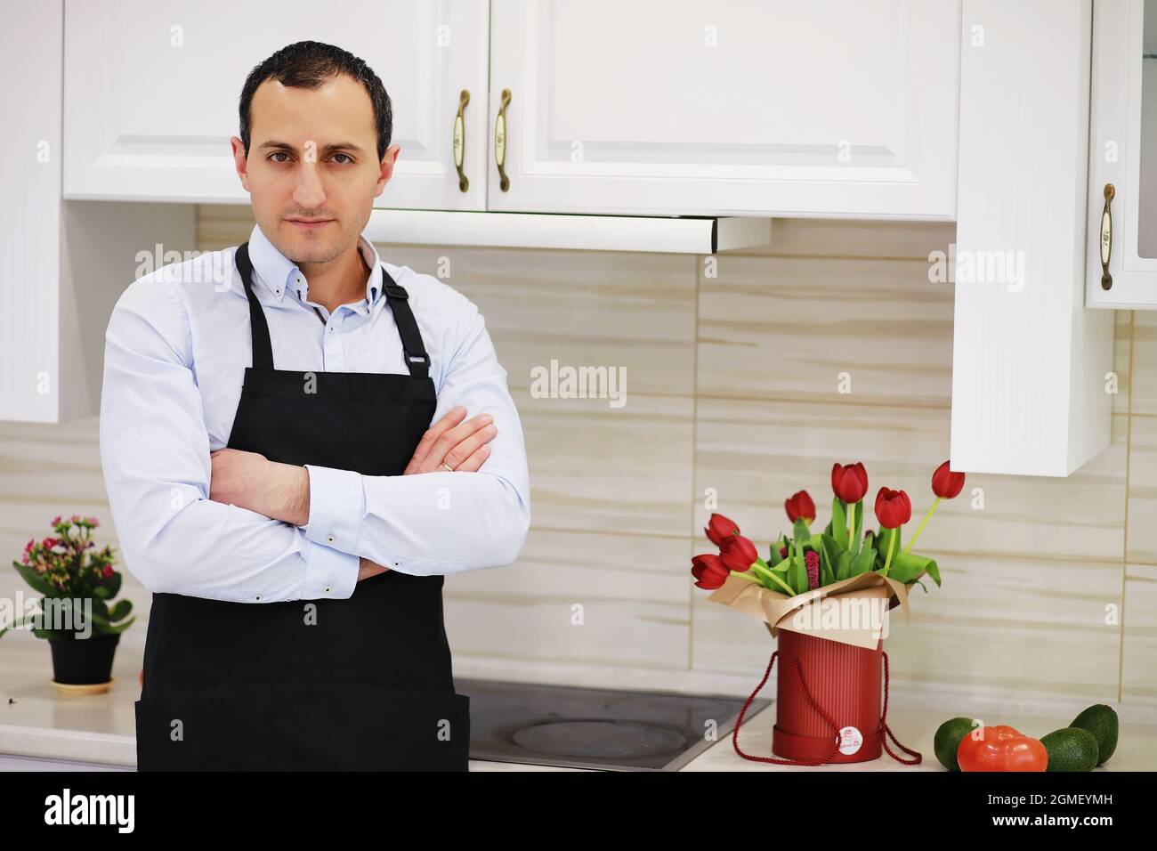 Master pastry chef in front of a desk. Cooking desserts at home. The ...