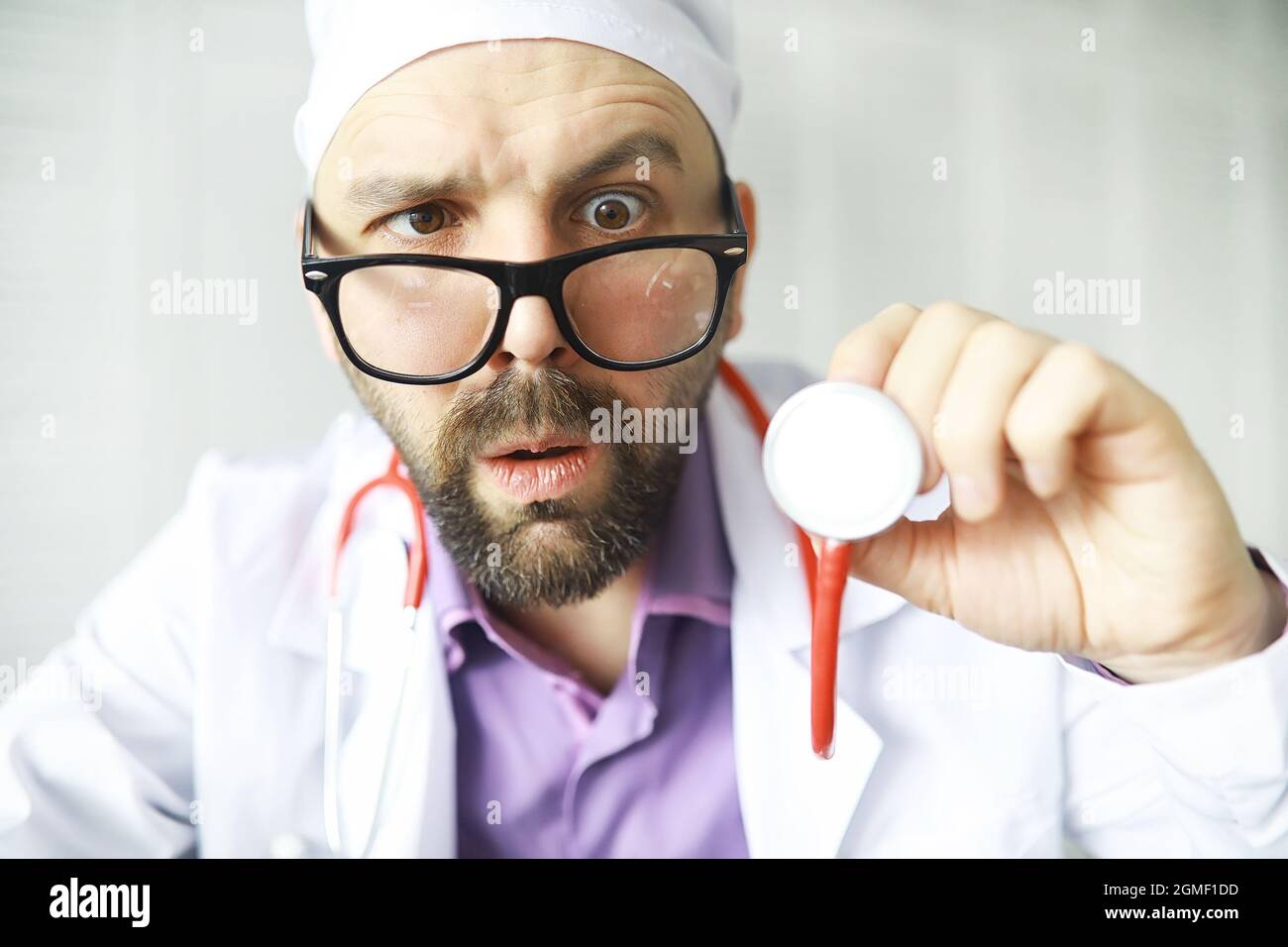 A cross-eyed bearded man is looking into the frame. Eye disease. The ...