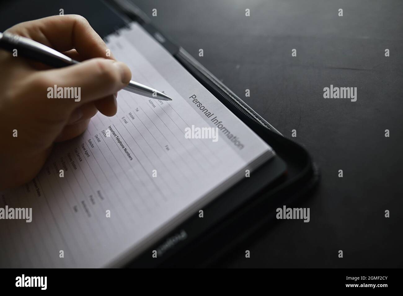 Filling out a form with personal information. Documents in a folder on ...