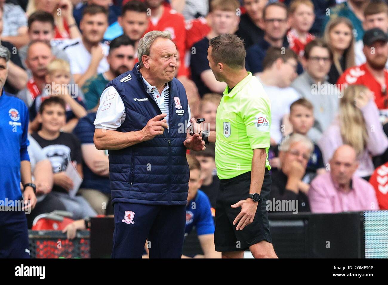 Referee David Webb walks over to speak to Neil Warnock manager of ...