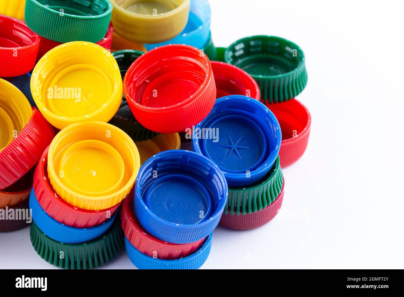 Group of multi colored bottle caps on white background Stock Photo - Alamy