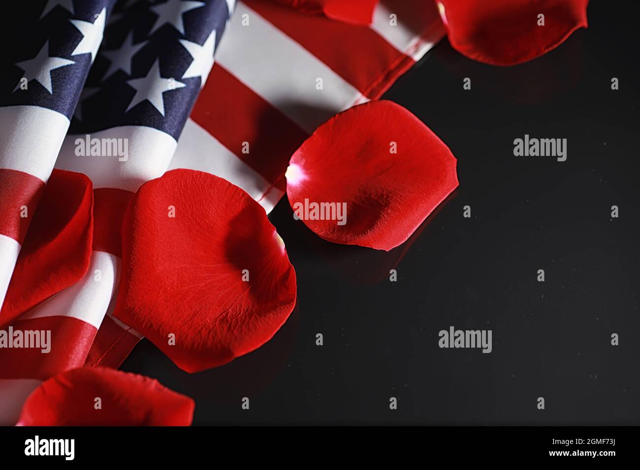 American flag and rose flower on table. Symbol of the United States of ...