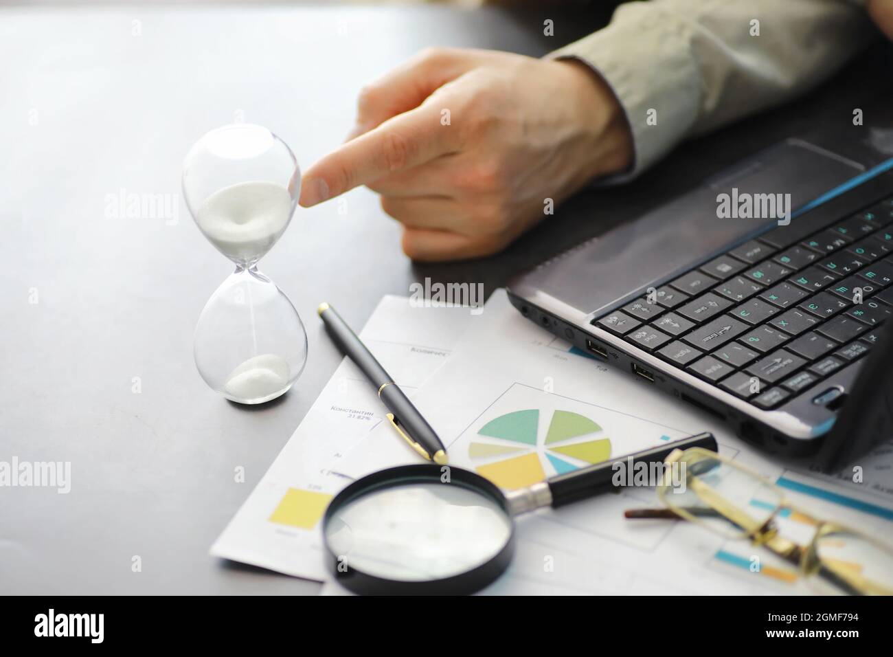 Working time symbolizes an hourglass. Office desk with insurance ...