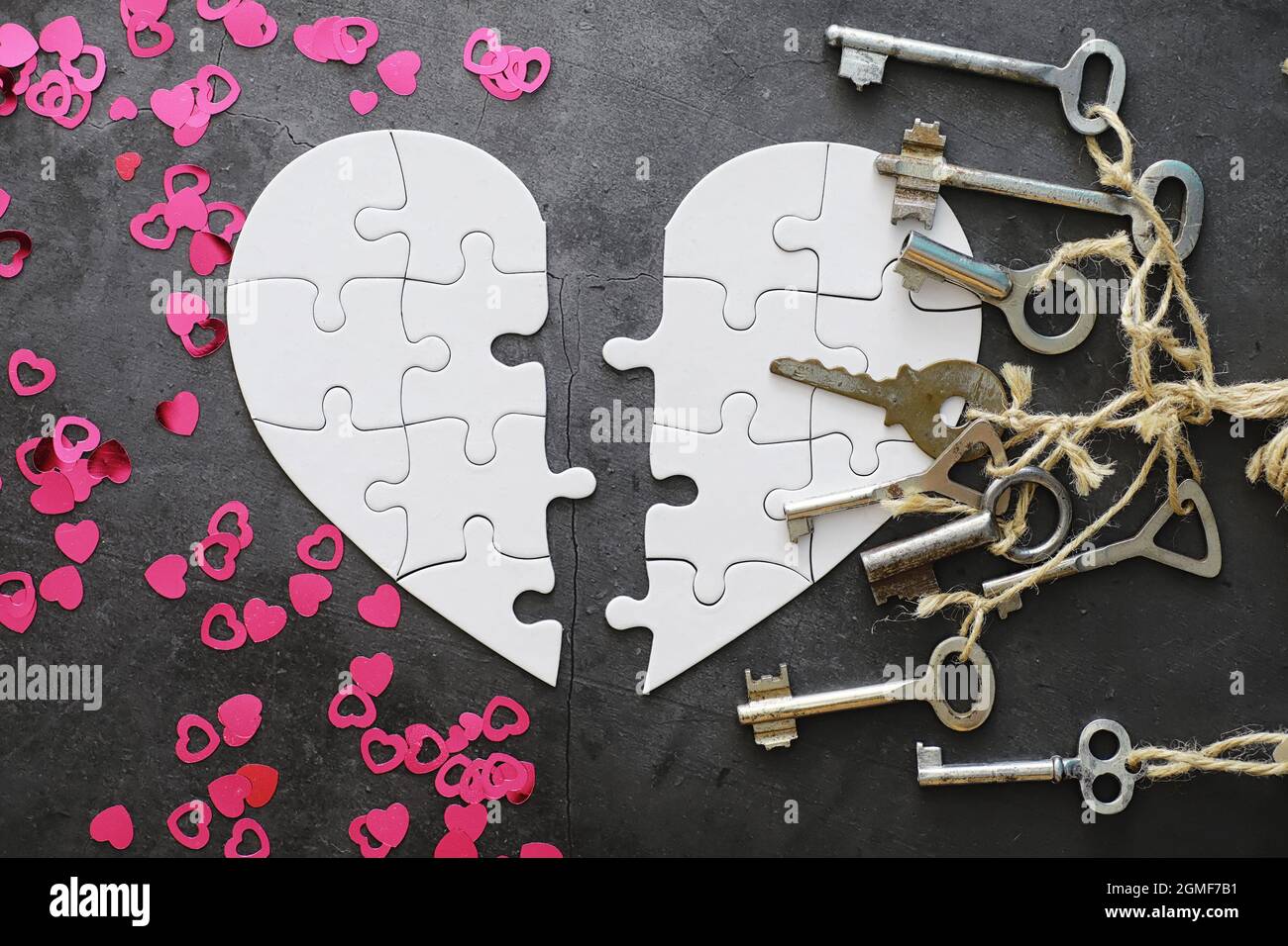 White heart-shaped puzzle. Heart affairs. Undivided love. Broken heart ...