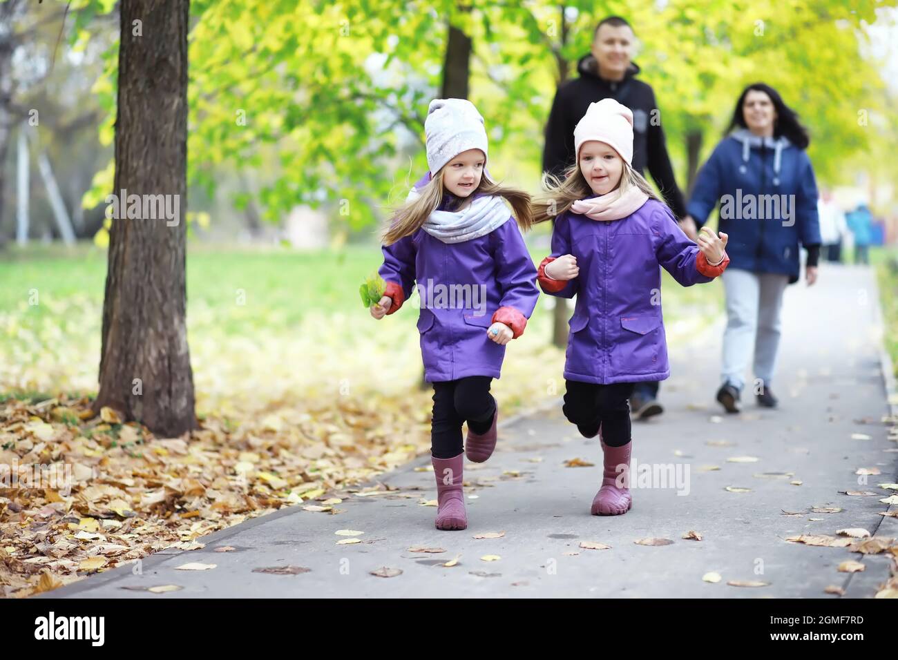 Children for a walk in autumn park. Leaf fall in the park. Family. Fall ...