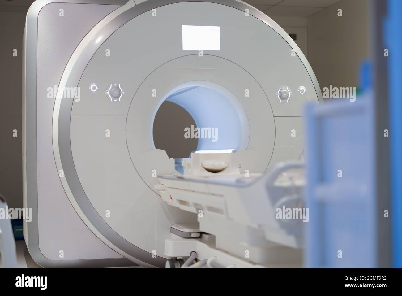 Modern magnetic resonance imaging machine standing in clinic background ...