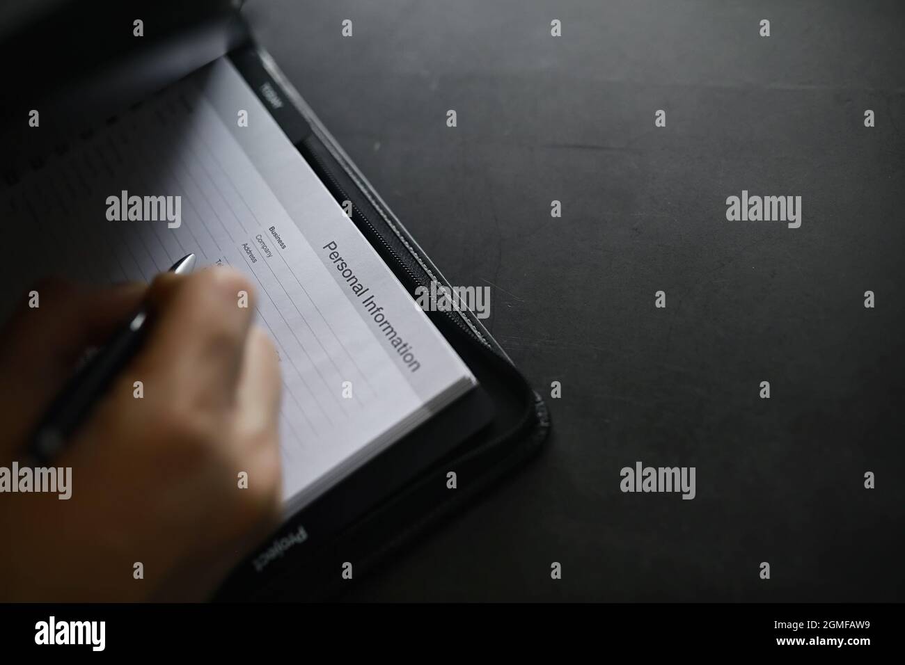 Filling out a form with personal information. Documents in a folder on ...