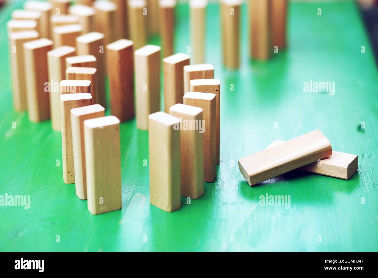 Stick wood block standing on stacked square wood blocks, abstract ...