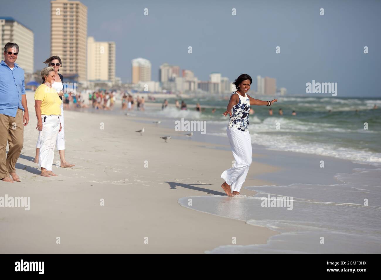 First Lady Michelle Obama walks along the beach with, from left, Dan ...
