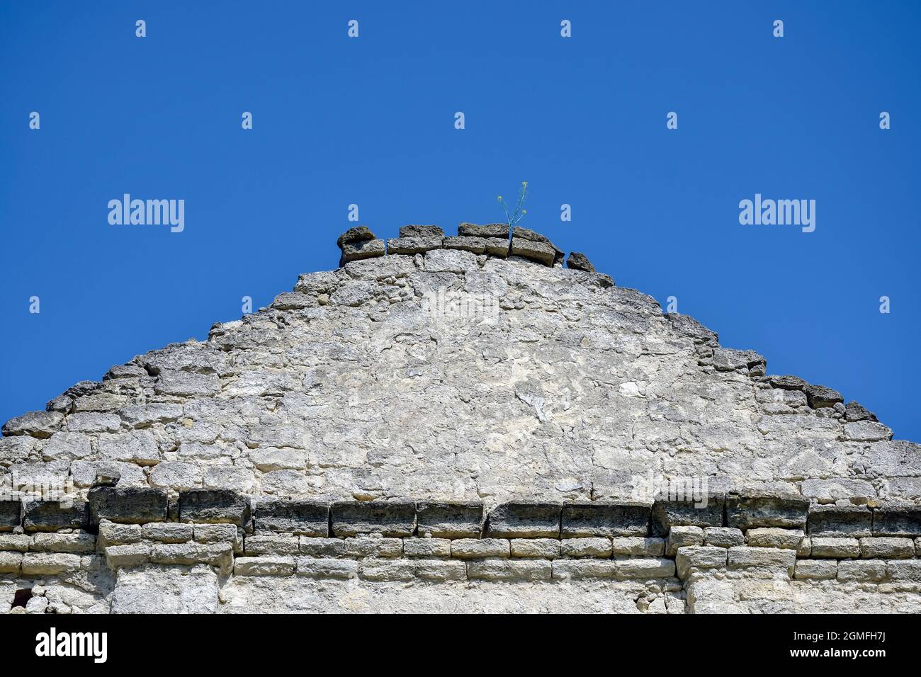 Ruined roof of an ancient building against clear sky. Brickwork, ruins ...