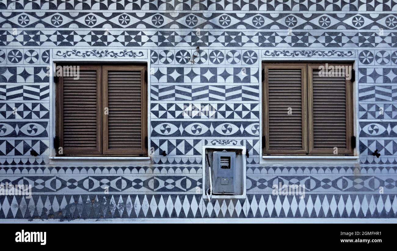 old window with shutters and ornately painted wall, Pirgi, Chios, Greek ...