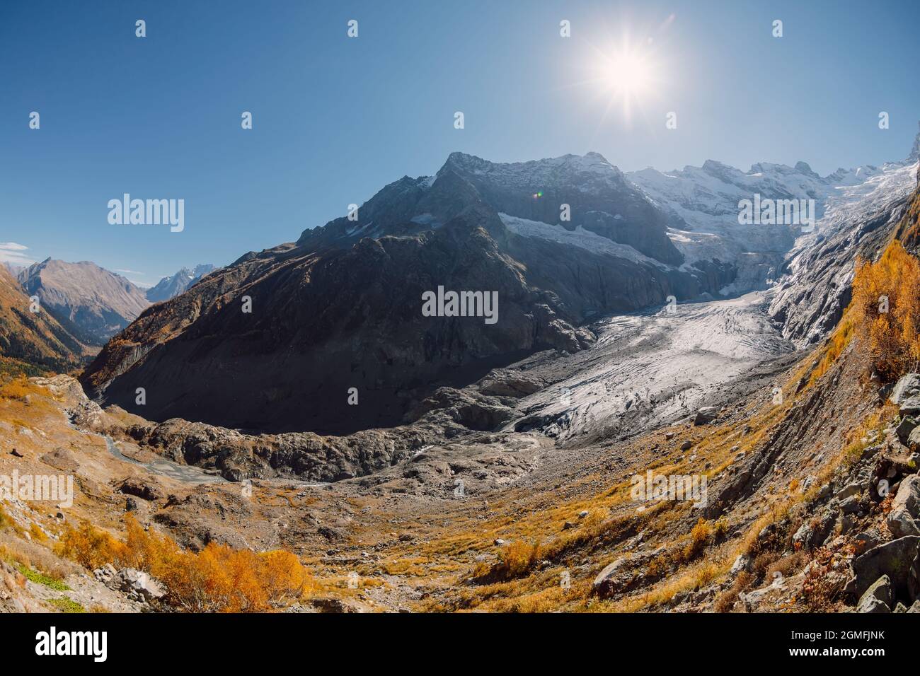 Rocky mountains and glacier. Peak of mountain and ice glacier in Dombay ...