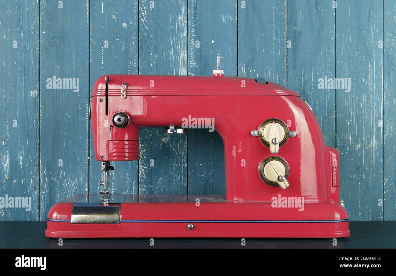 Household appliances - Front view old retro red sewing machine wooden ...
