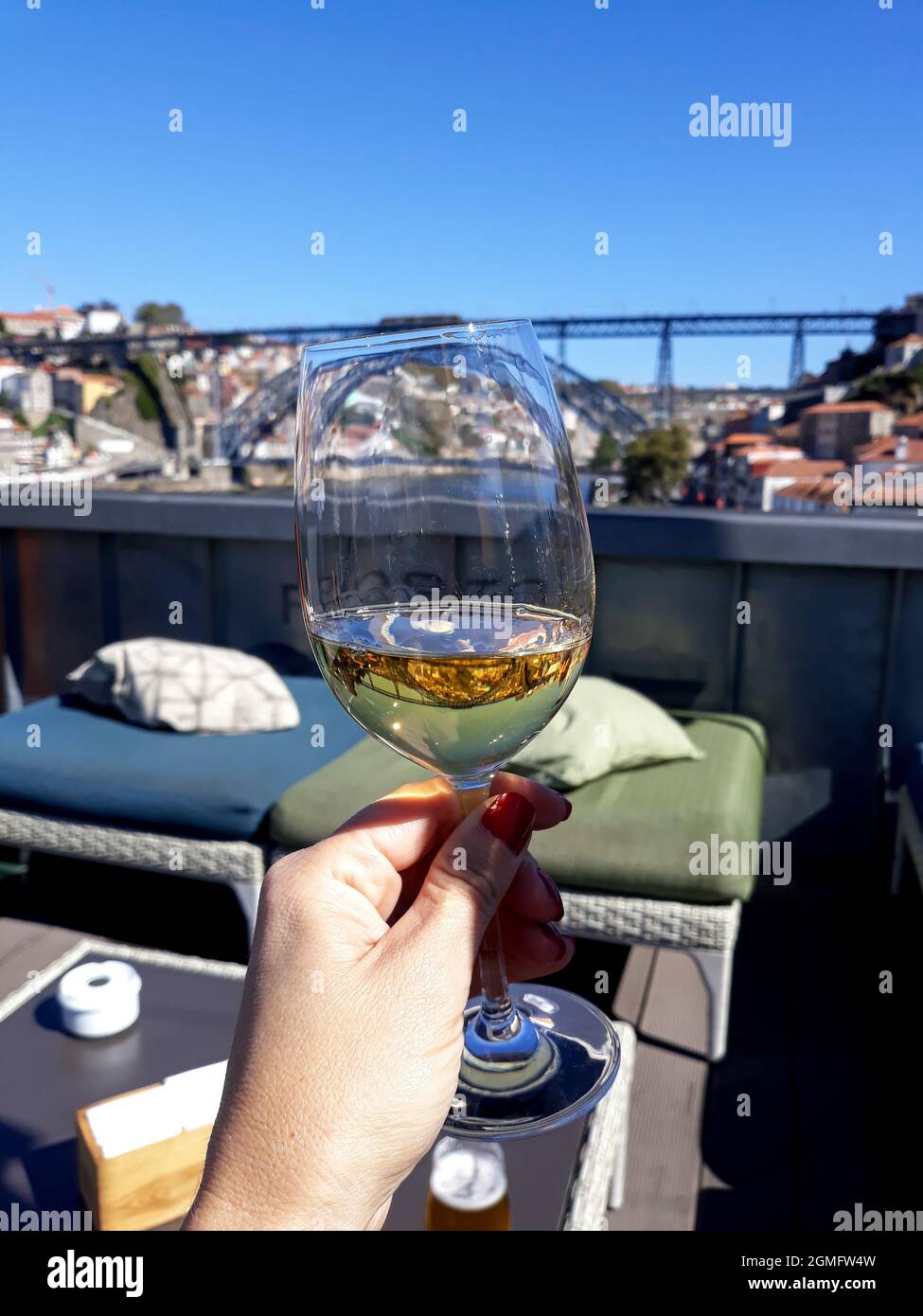 woman's hand raising a glass of wine Stock Photo - Alamy