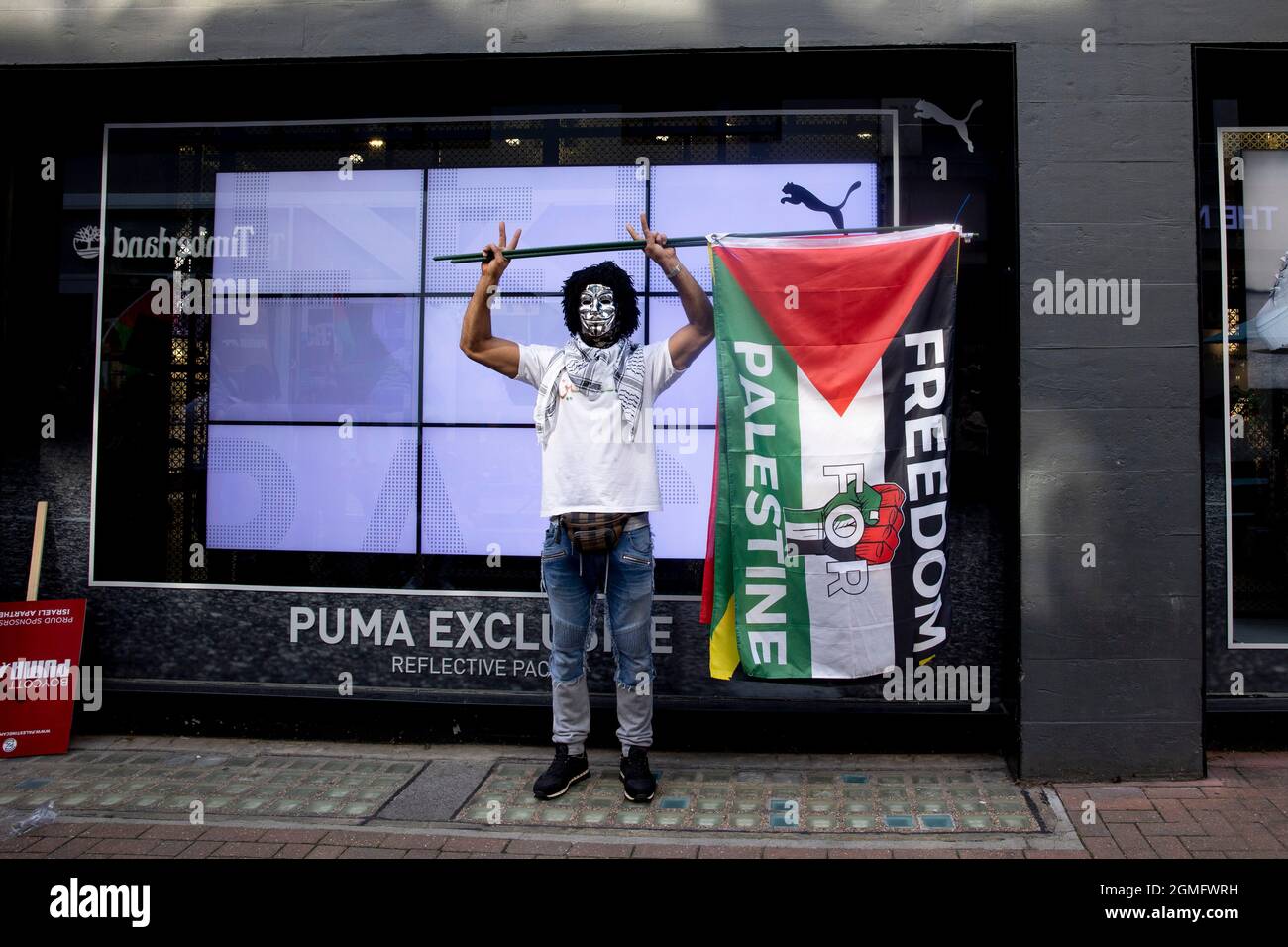 London, UK. 18th Sep, 2021. A masked protester holding a Palestinian ...