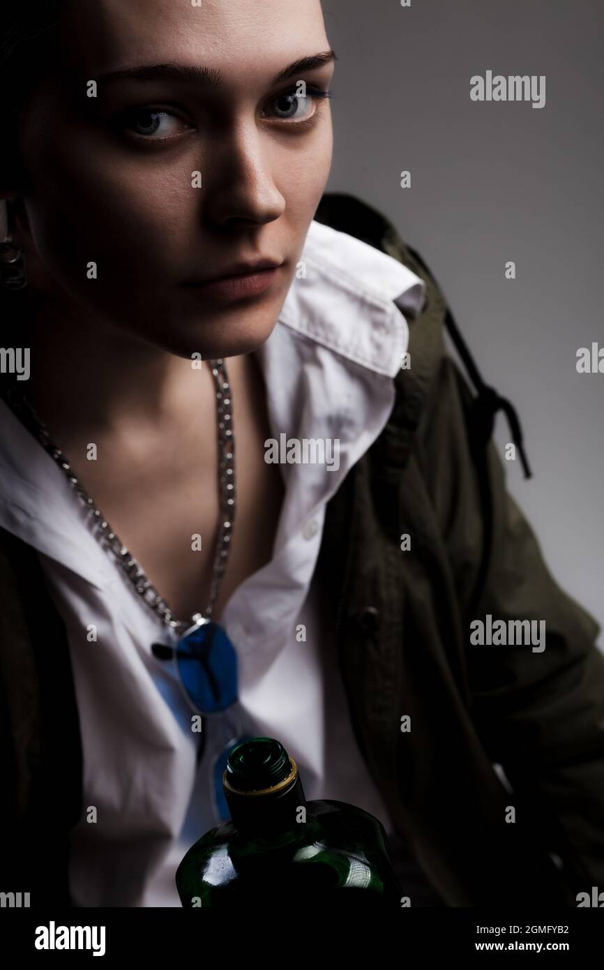 studio portrait of a beautiful girl holding alcohol bottle Stock Photo ...