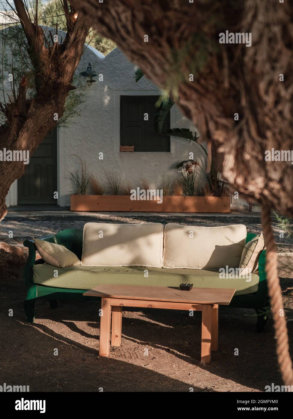 Vertical shot of a small couch with a wooden table in front of it near ...