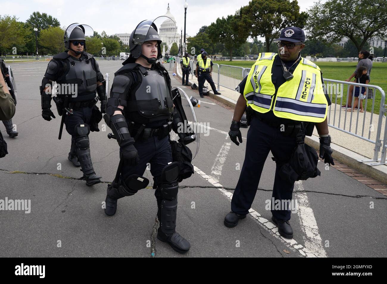 Police officers in riot gear stand guard around a perimeter of the U.S ...
