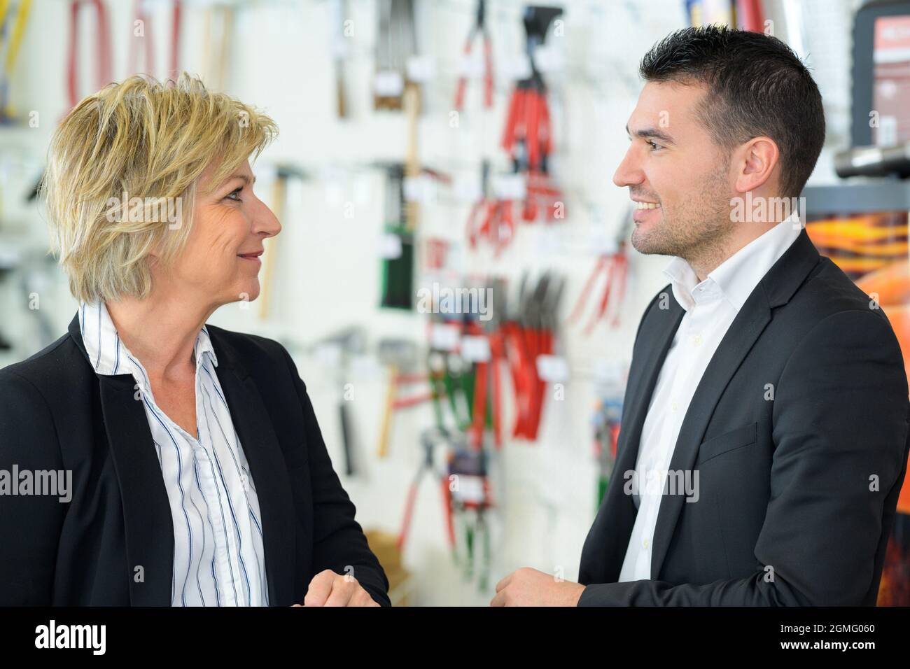 female customer buying from salesman Stock Photo - Alamy