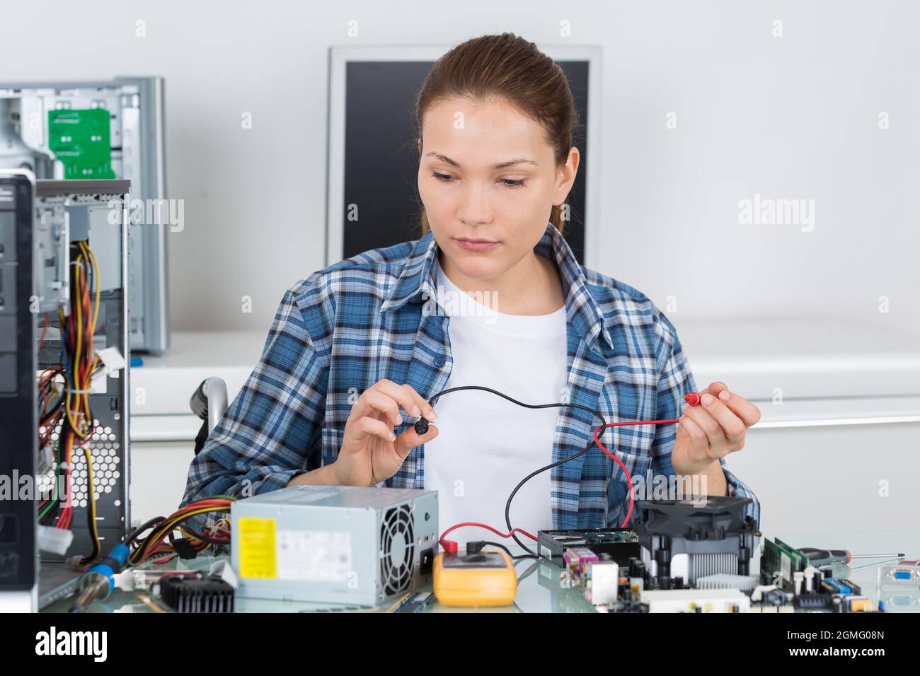 female computer technician using multimeter Stock Photo - Alamy