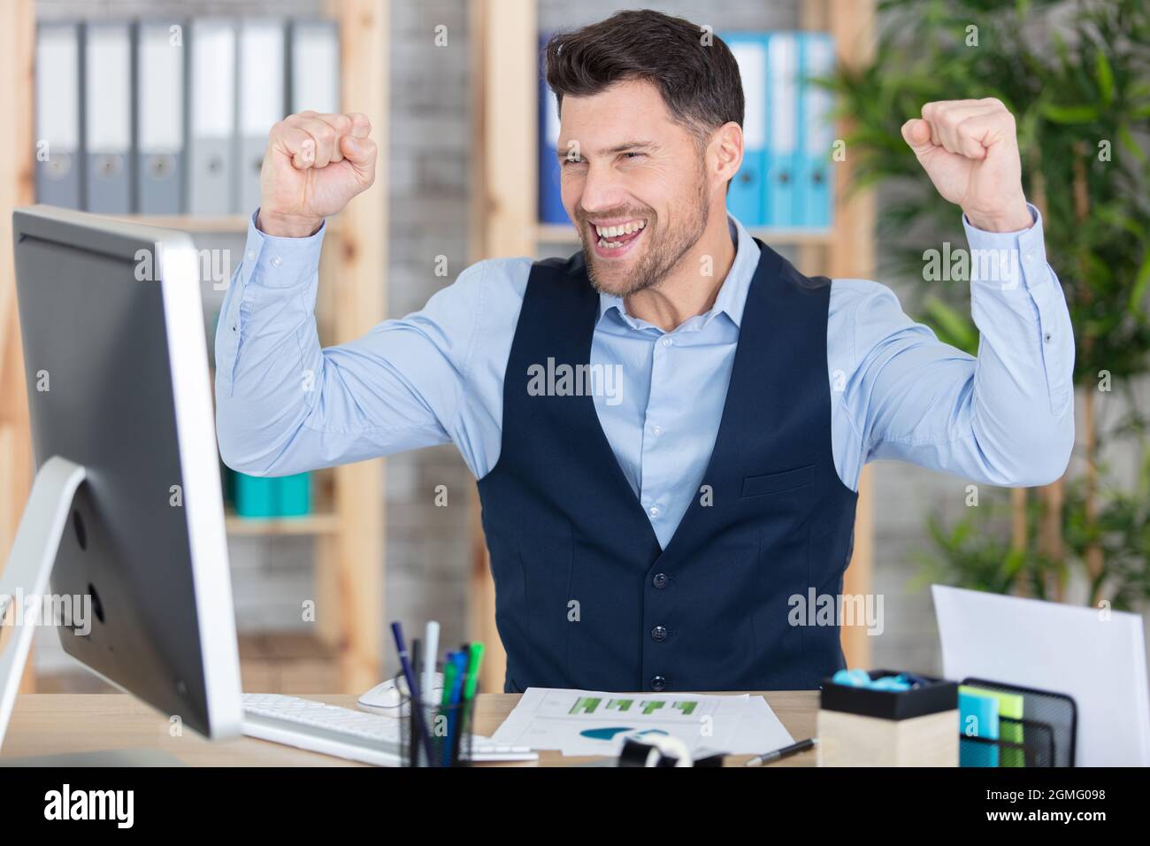 creative male office worker with computer Stock Photo - Alamy